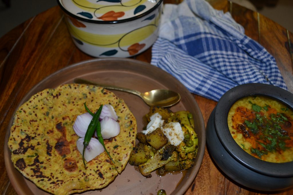 Clay Pot slow cooked Urad Daal served with Bathua Parantha - MilesnMeals